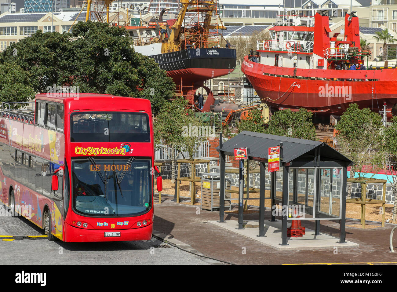 Red tourist bus entering cape town harbour area of cape town, south ...