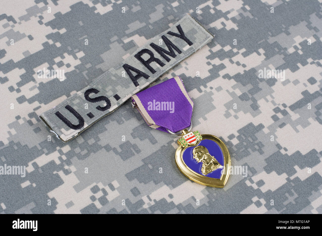 Purple Heart award on US ARMY camouflage uniform Stock Photo - Alamy