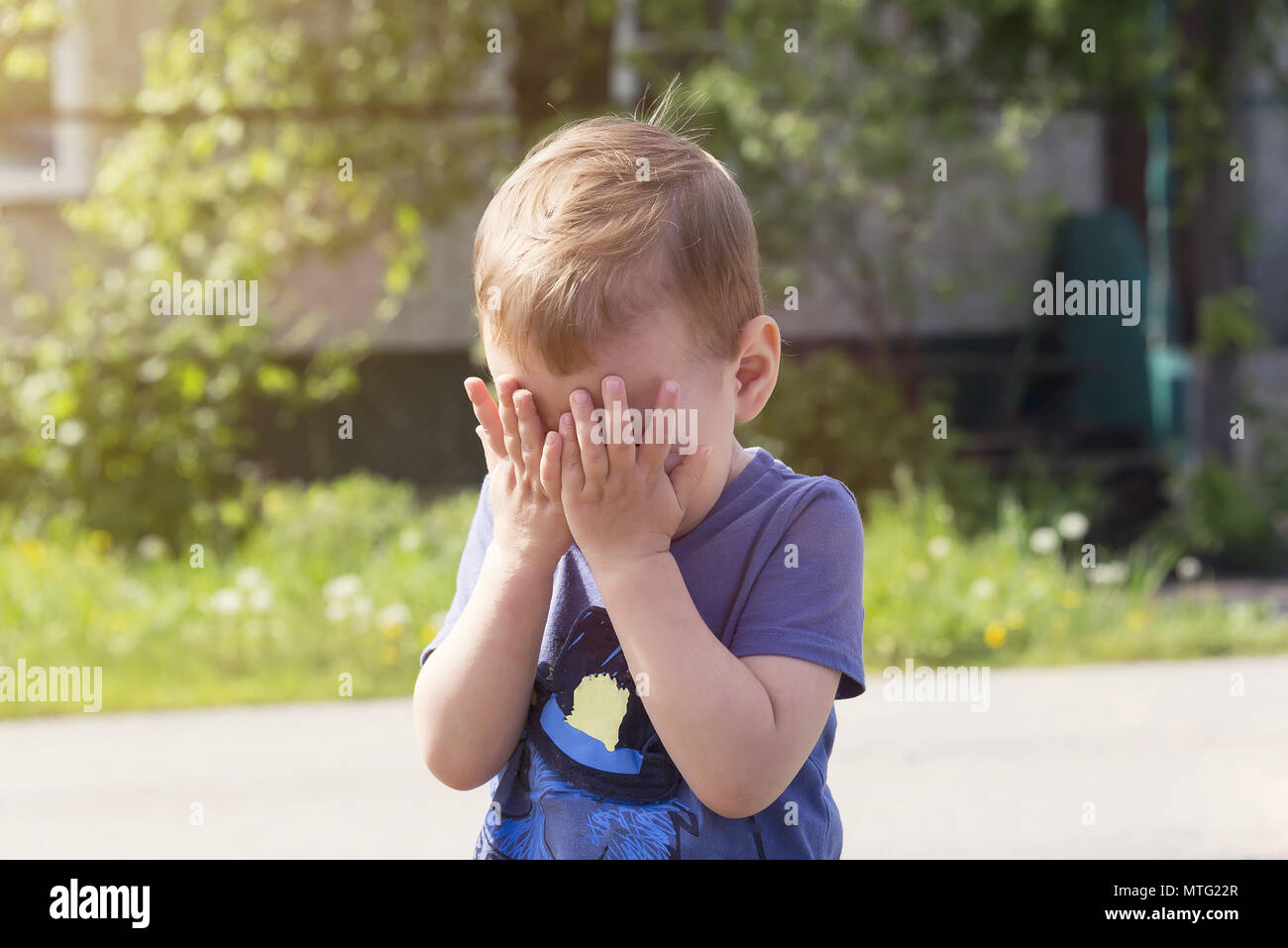 the child cries of resentment, sobs sobbingly covering his face with ...