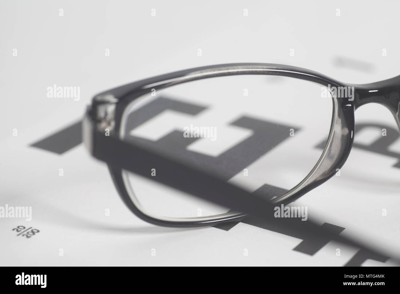 Eyeglasses on eyesight test chart background close-up Stock Photo - Alamy