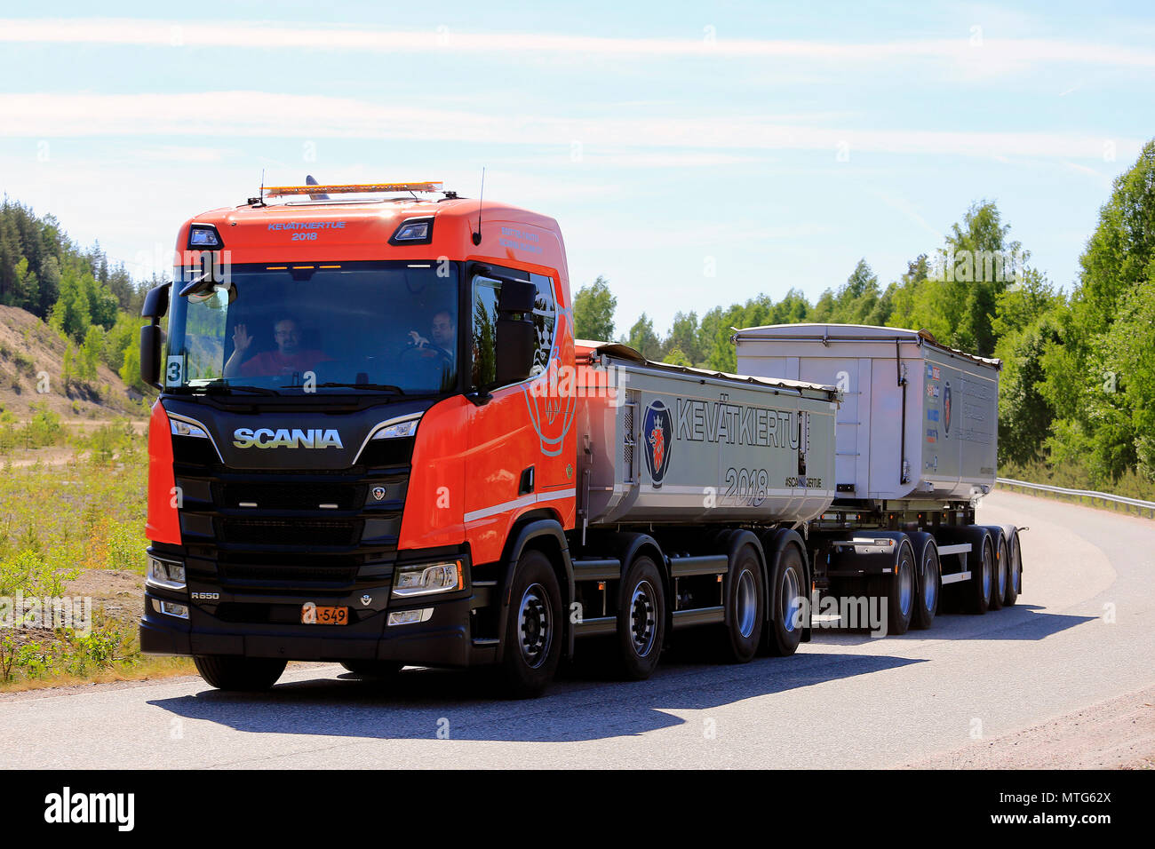 Orange Scania R650 gravel truck combination on road test on a sunny day ...
