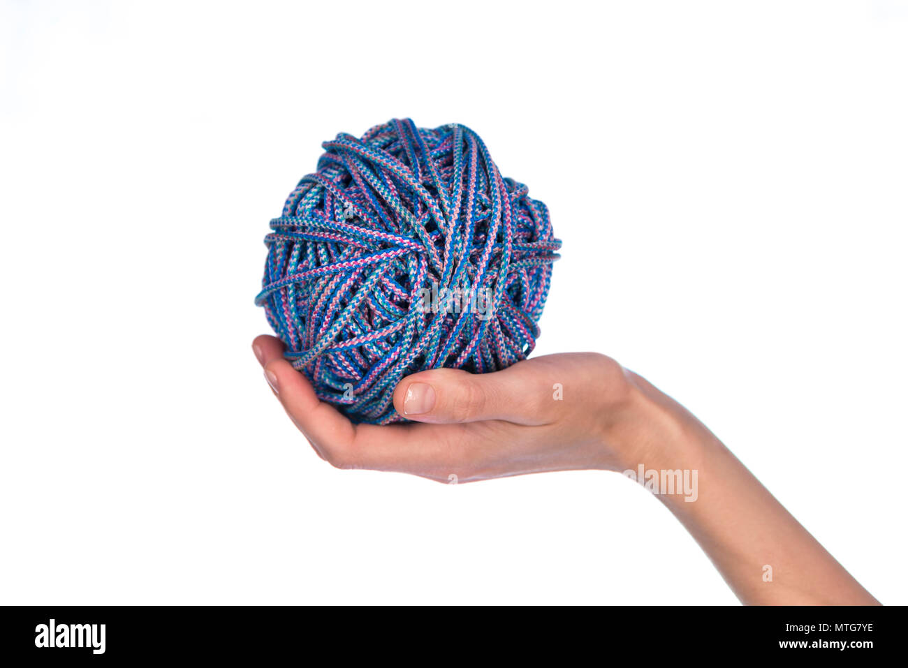 ball tangle of multi-colored rope on the palm of a woman on a white ...