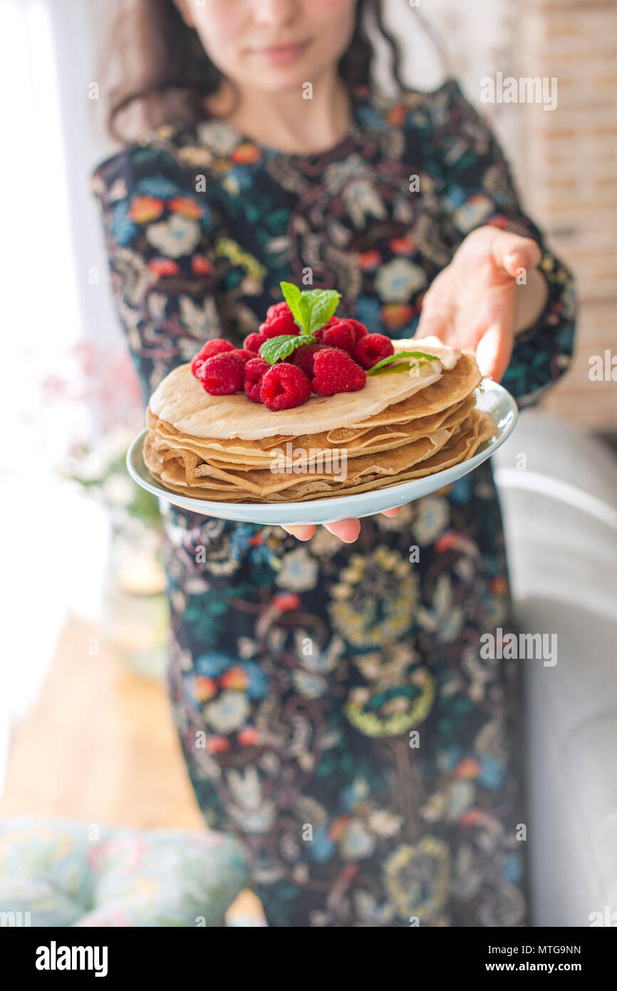 Photo of happy young woman standing at the kitchen in home cooking ...