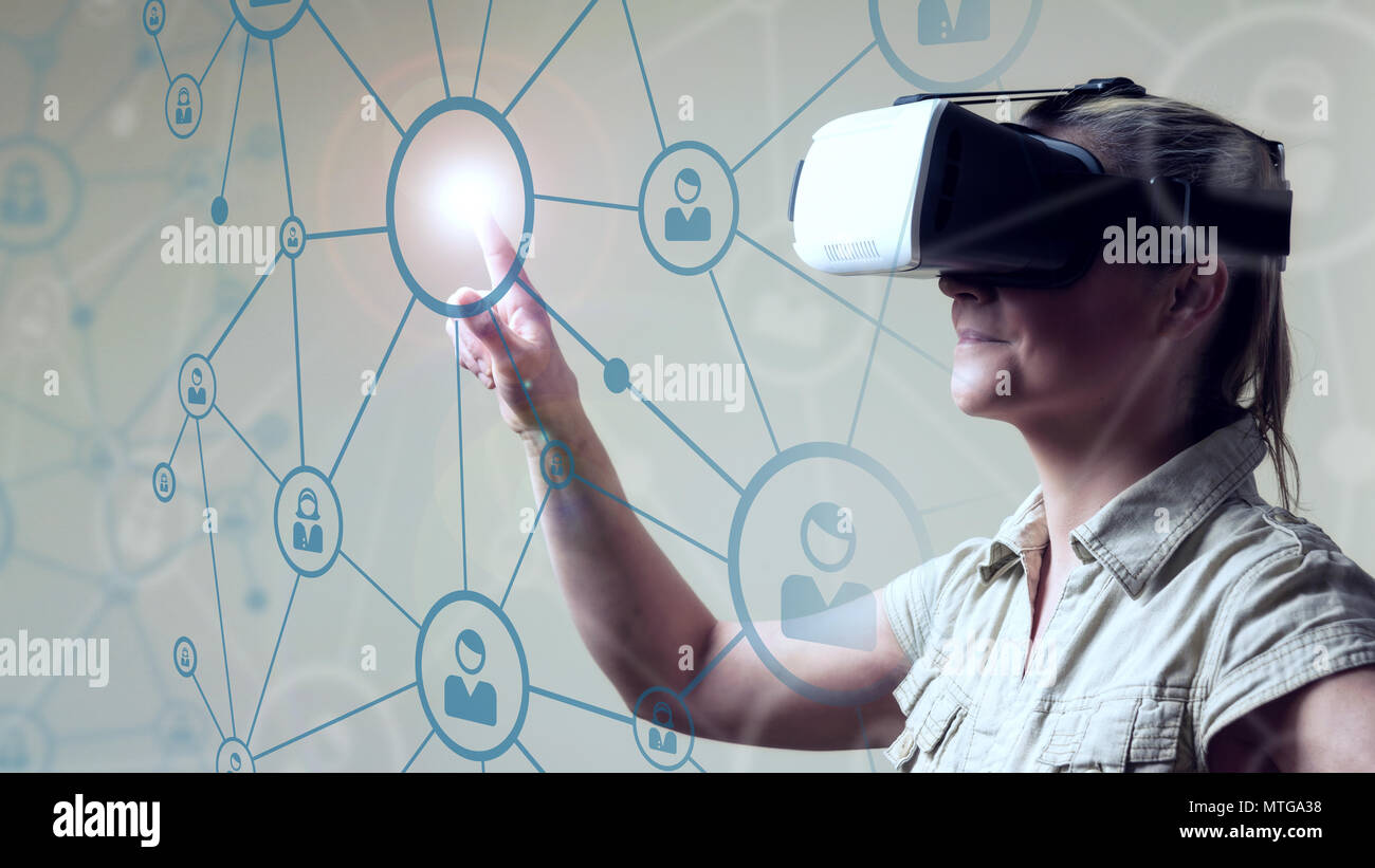 Young Woman looking through VR (Virtual Reality) glasses - Pointing ...