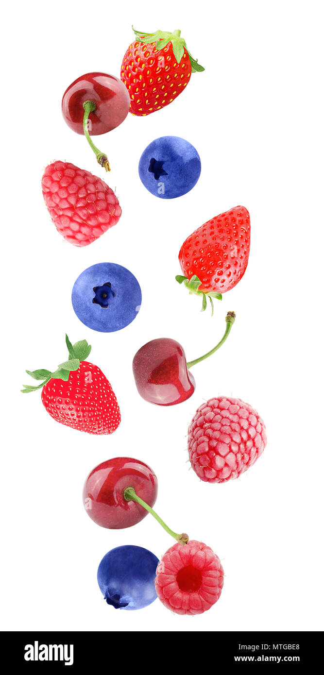 Isolated flying mixed berries. Falling strawberry, cherry raspberry and ...