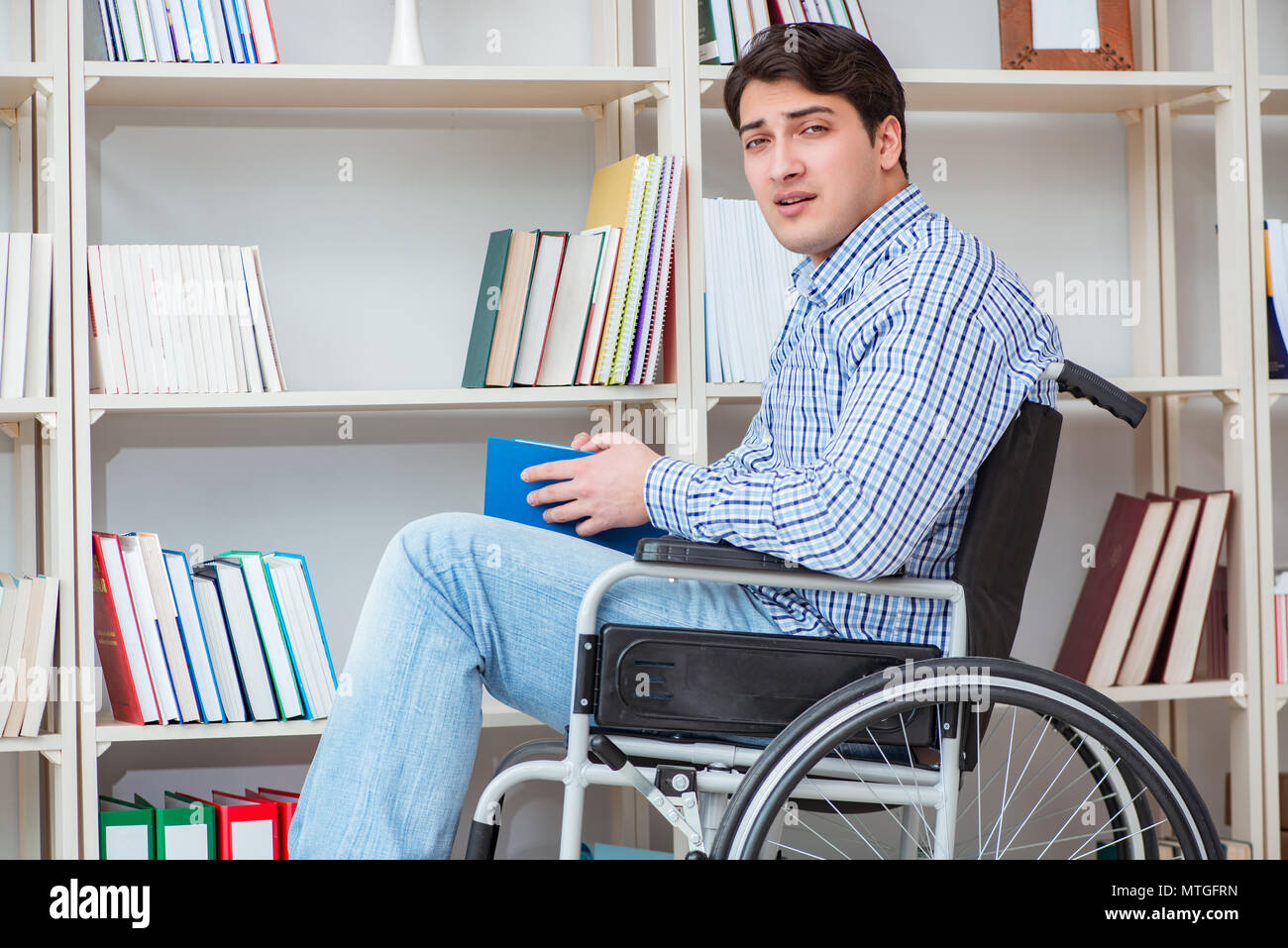 Disabled student studying in the library Stock Photo - Alamy