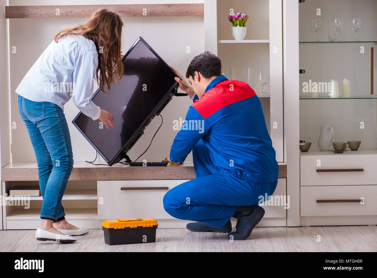 Repairman repairing tv at home Stock Photo - Alamy