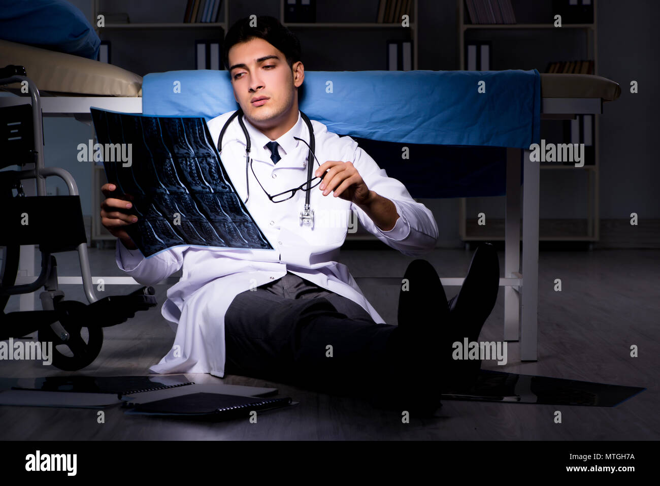 Doctor working night shift in hospital after long hours Stock Photo - Alamy