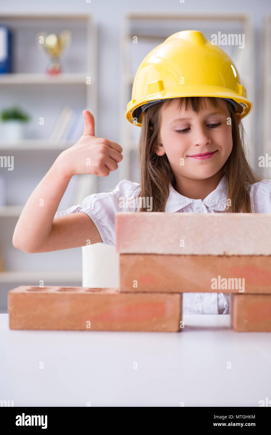 Young girl building with construction bricks Stock Photo - Alamy