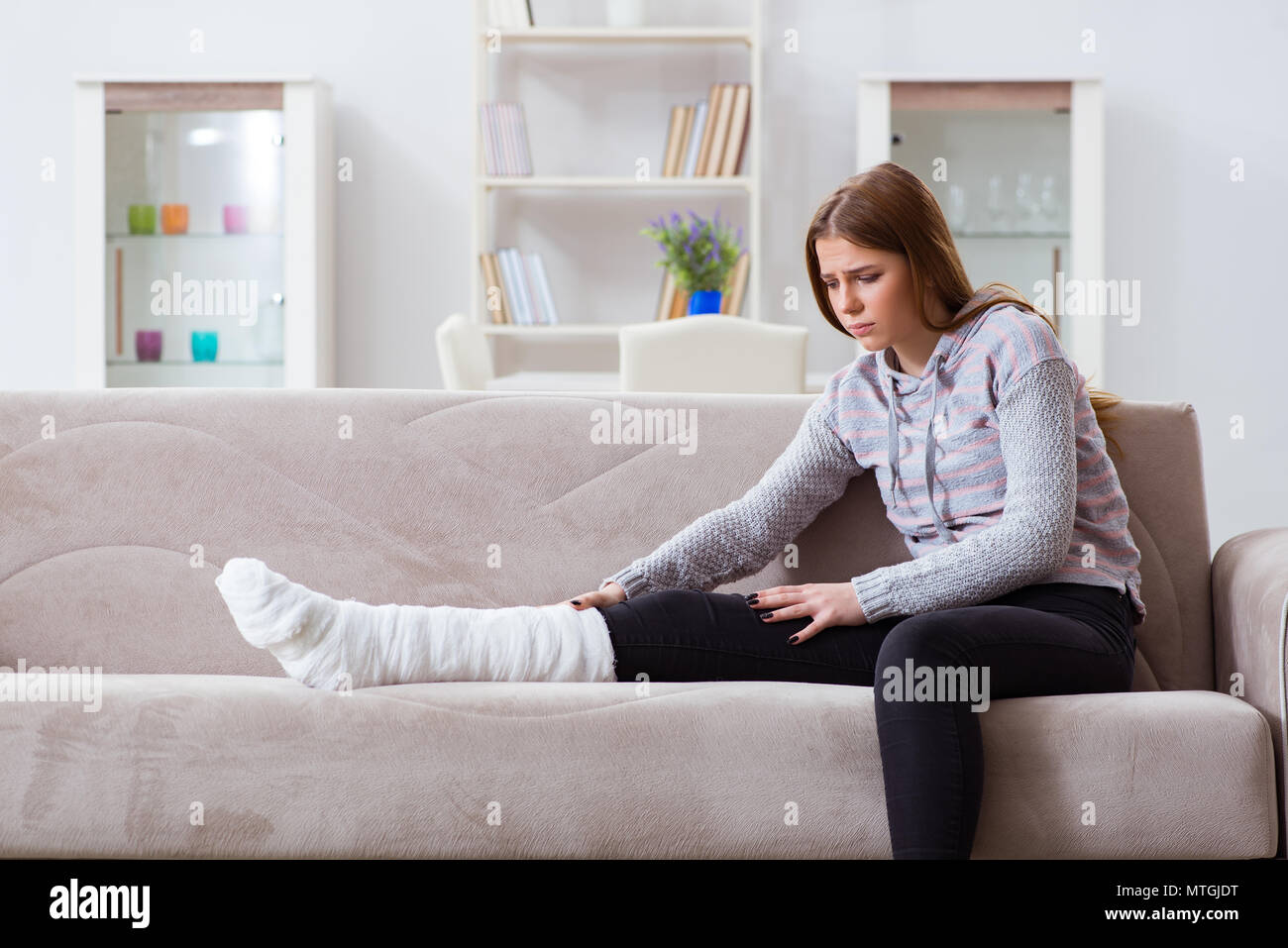 Young woman with broken leg at home Stock Photo - Alamy
