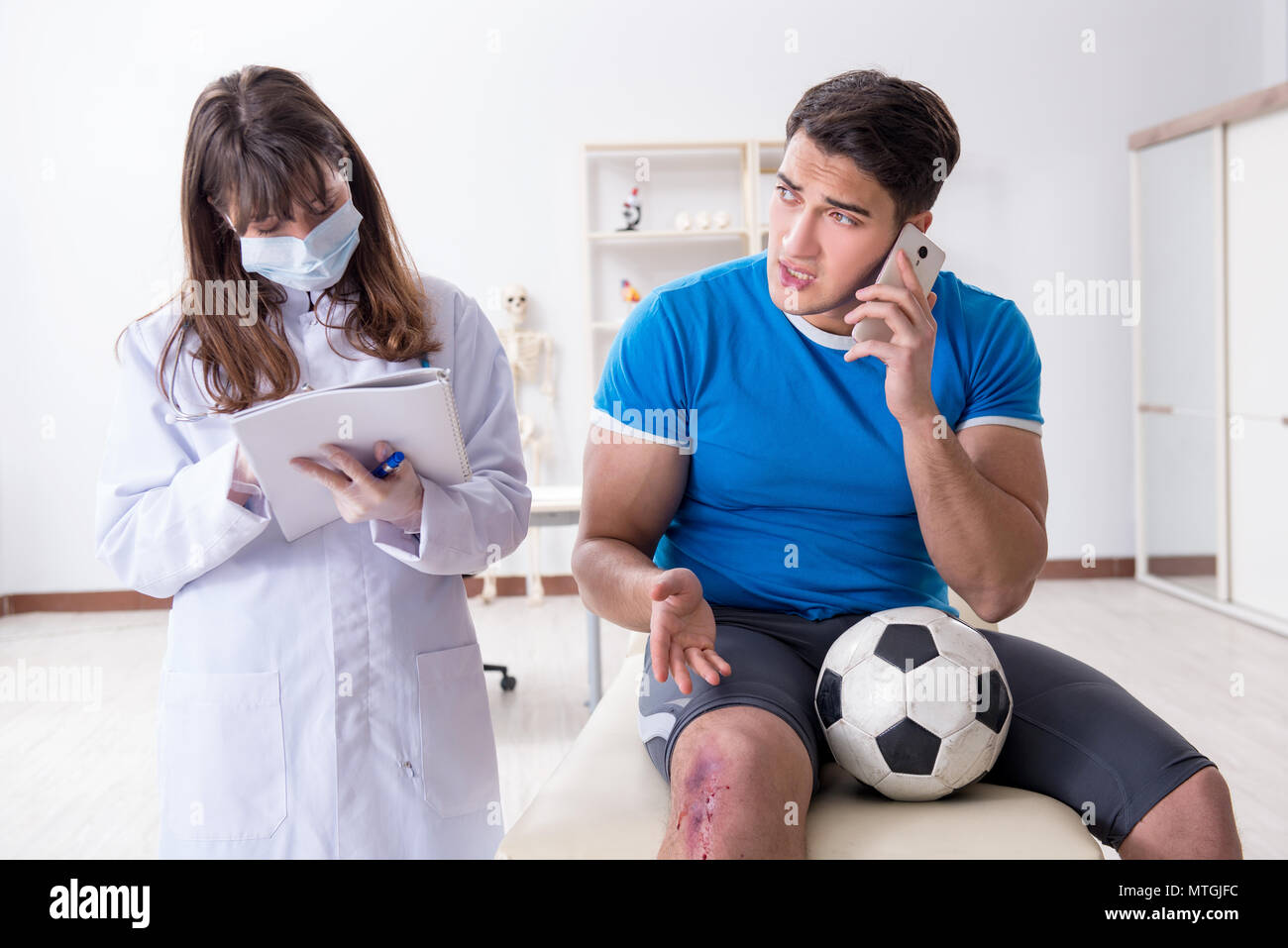 Football soccer player visiting doctor after injury Stock Photo - Alamy
