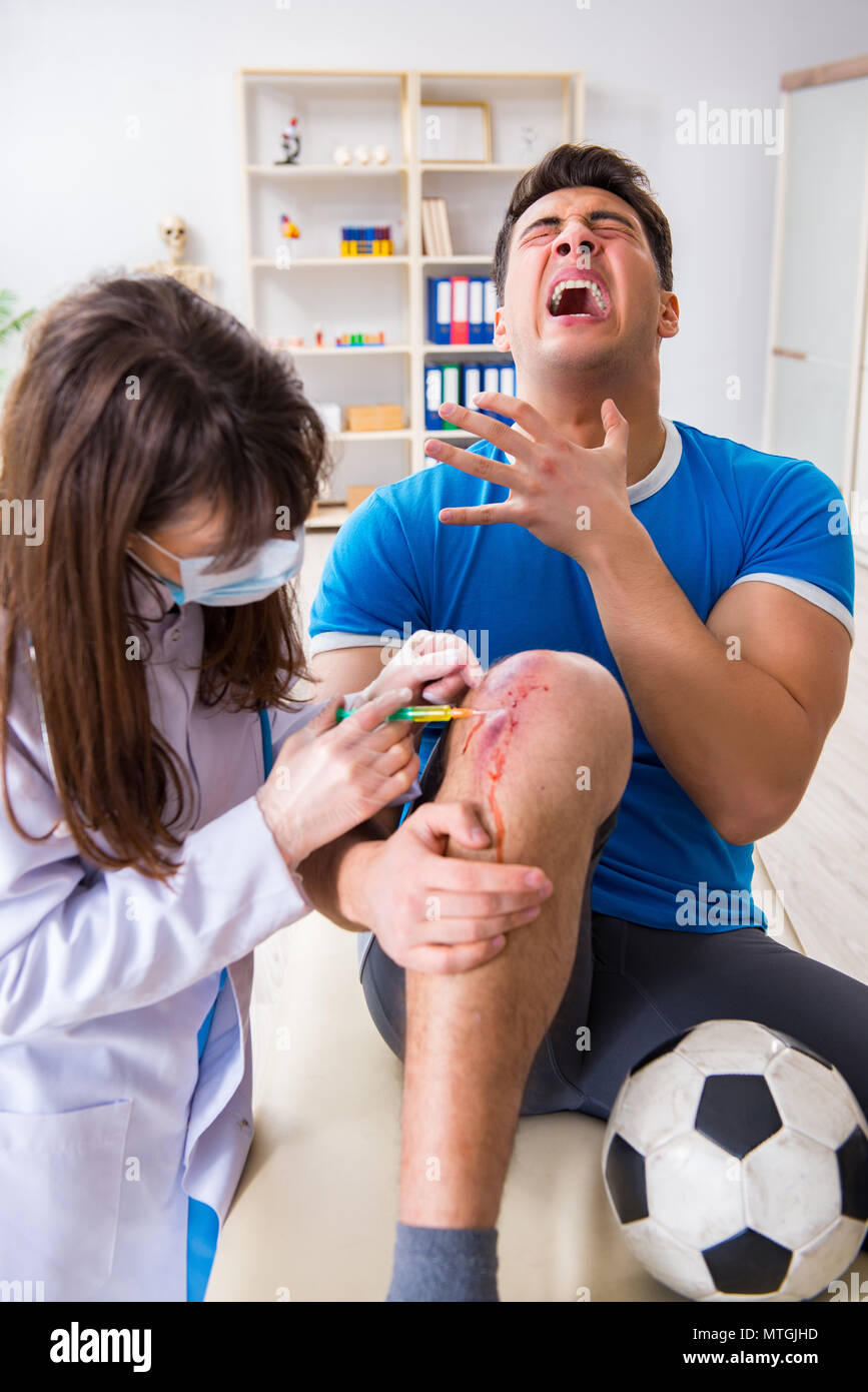 Football soccer player visiting doctor after injury Stock Photo - Alamy