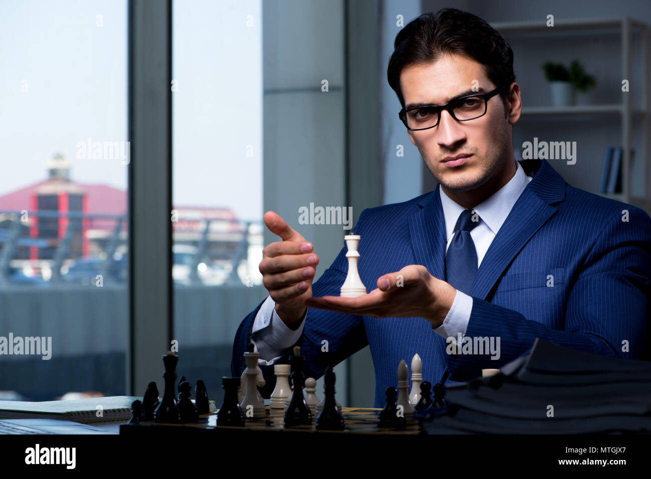 Businessman playing chess in strategy concept Stock Photo - Alamy