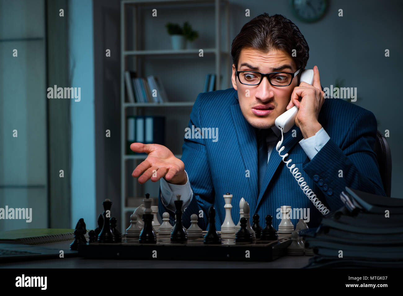 Businessman playing chess in strategy concept Stock Photo - Alamy