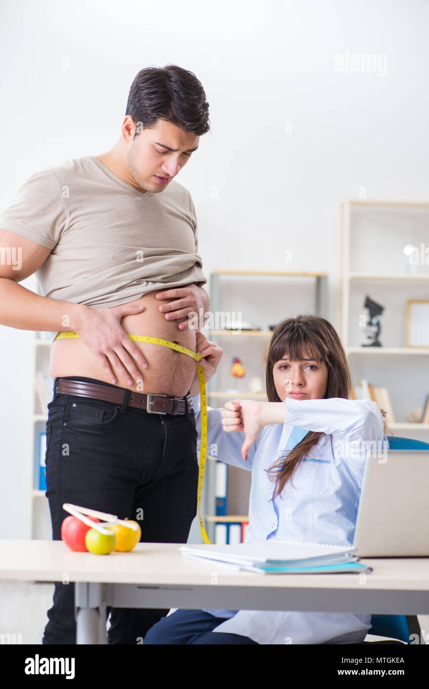Doctor dietician giving advices to fat overweight patient Stock Photo ...