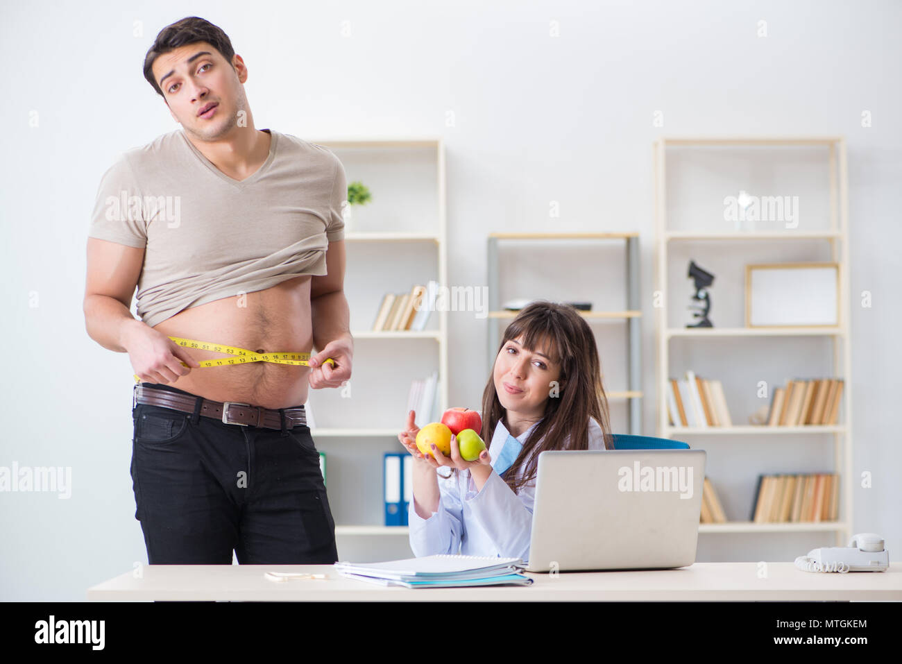 Doctor dietician giving advices to fat overweight patient Stock Photo ...