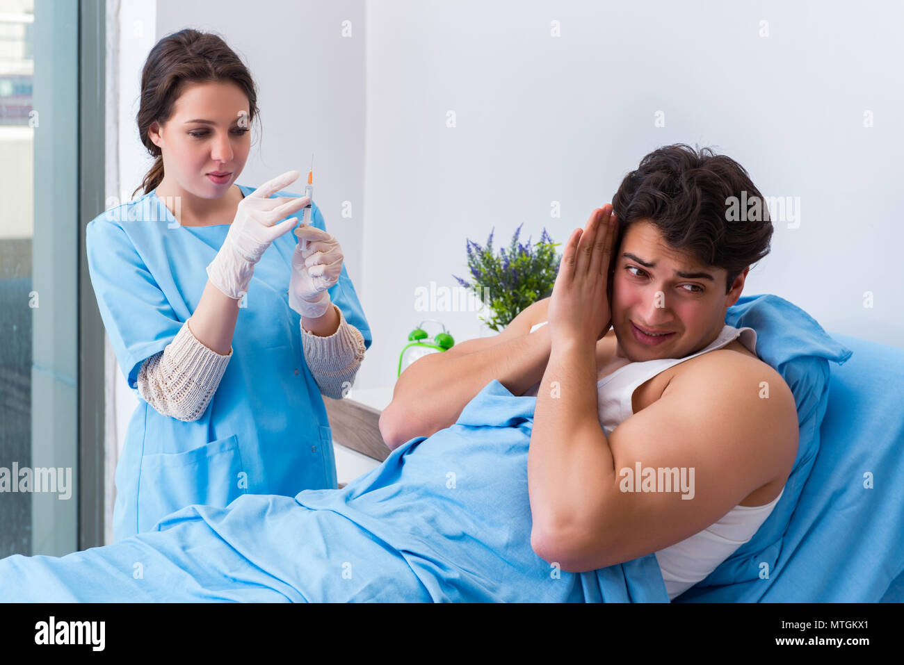 Doctor doing medical injection in hospital room Stock Photo - Alamy
