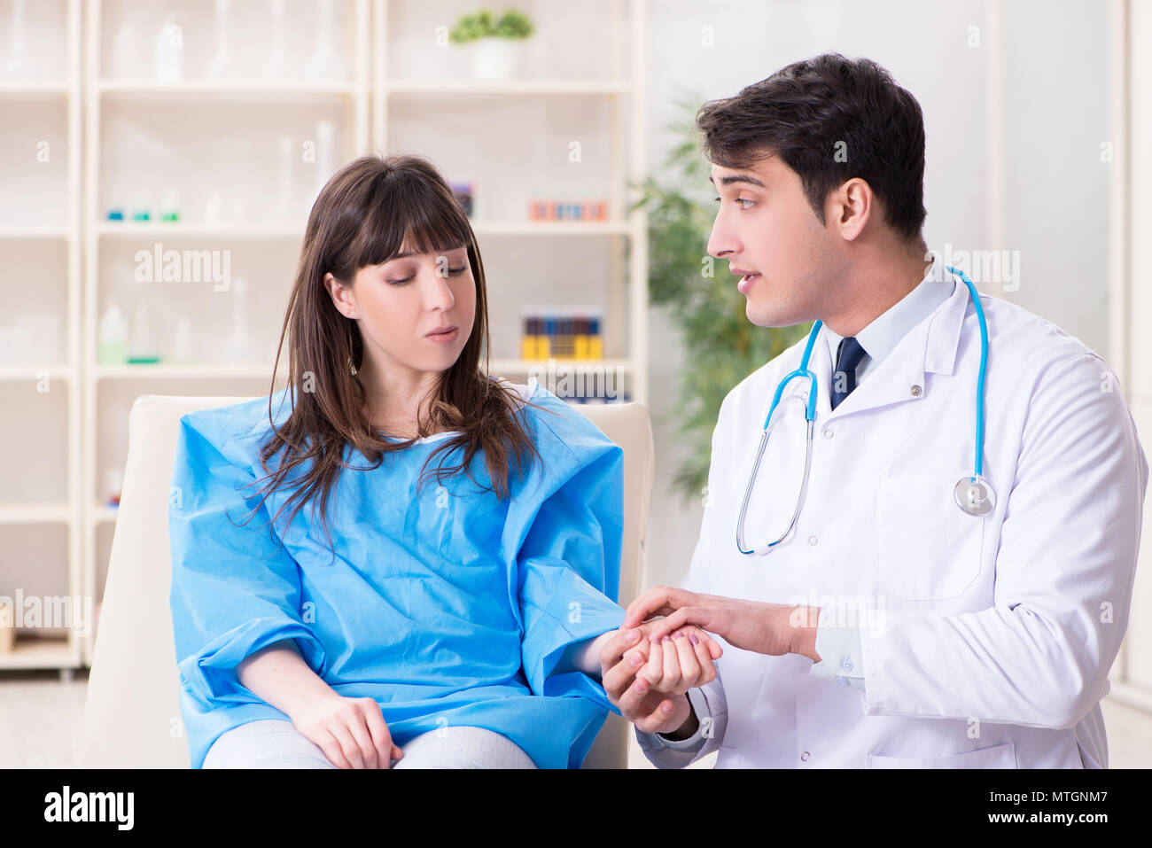 Male doctor checking up female patient in hospital Stock Photo - Alamy