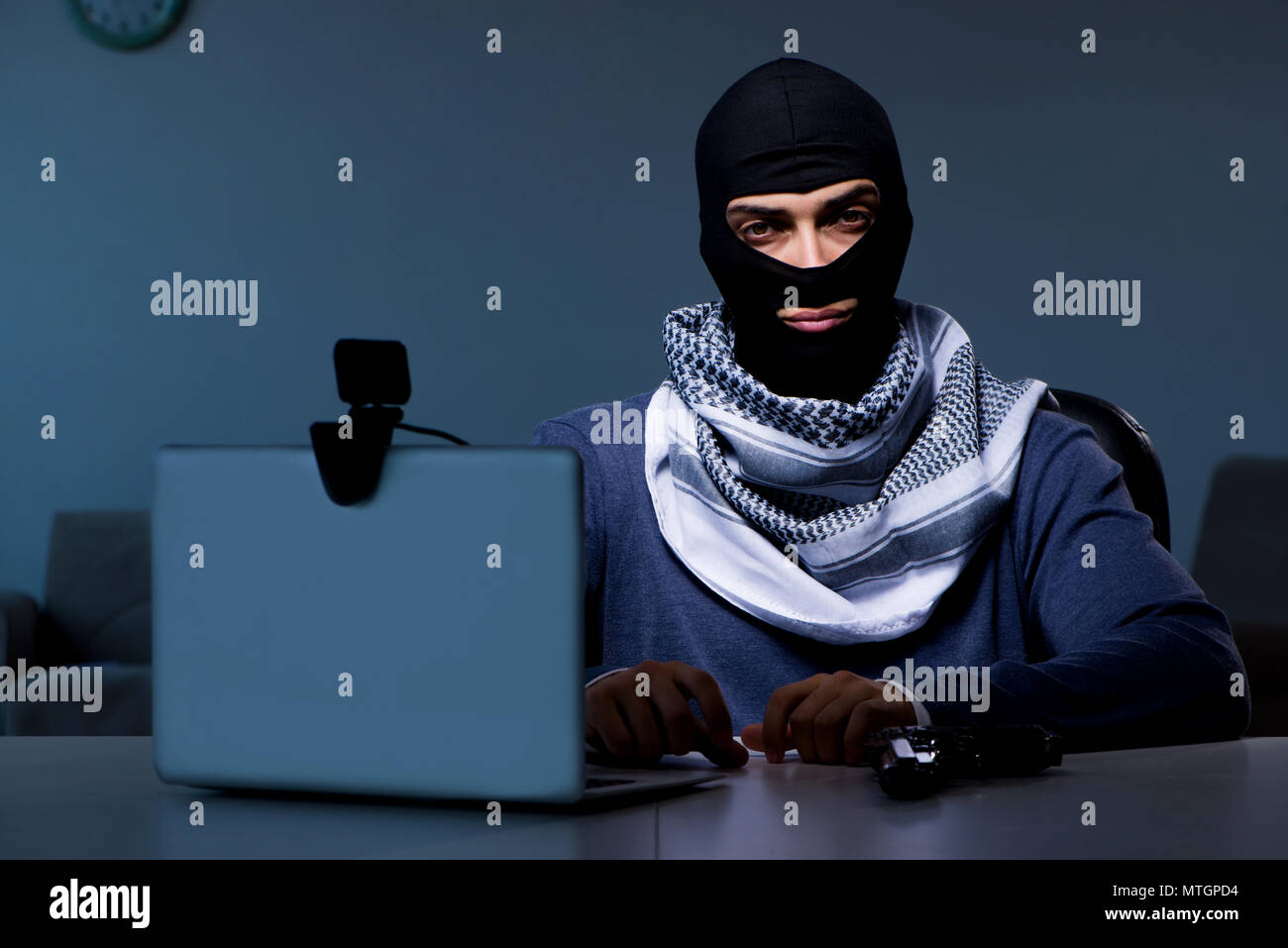 Hacker wearing balaclava mask hacking computer Stock Photo - Alamy