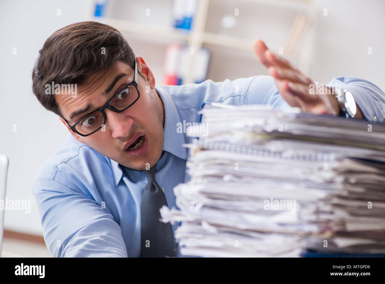 Extremely busy businessman working in office Stock Photo - Alamy
