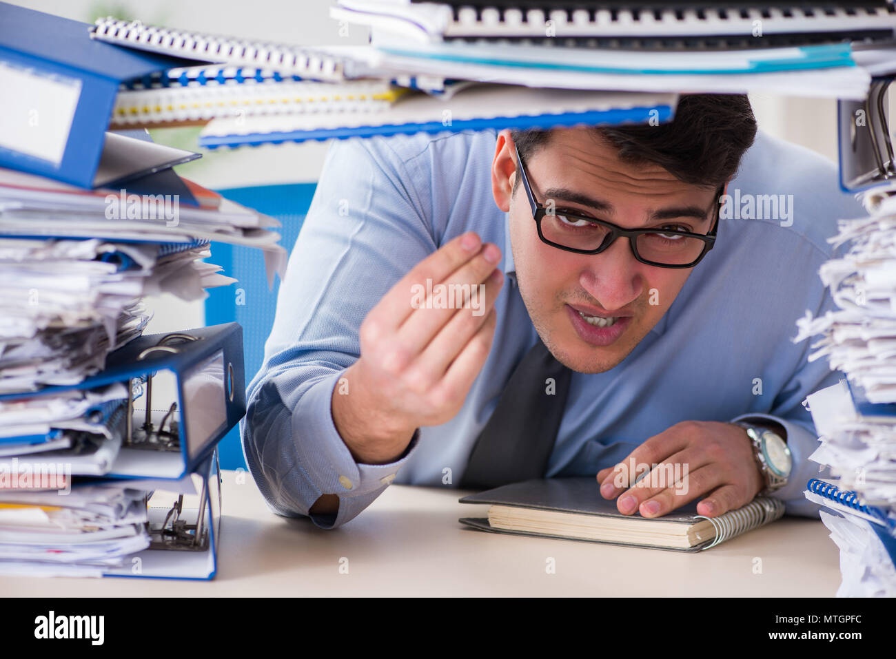 Extremely busy businessman working in office Stock Photo - Alamy