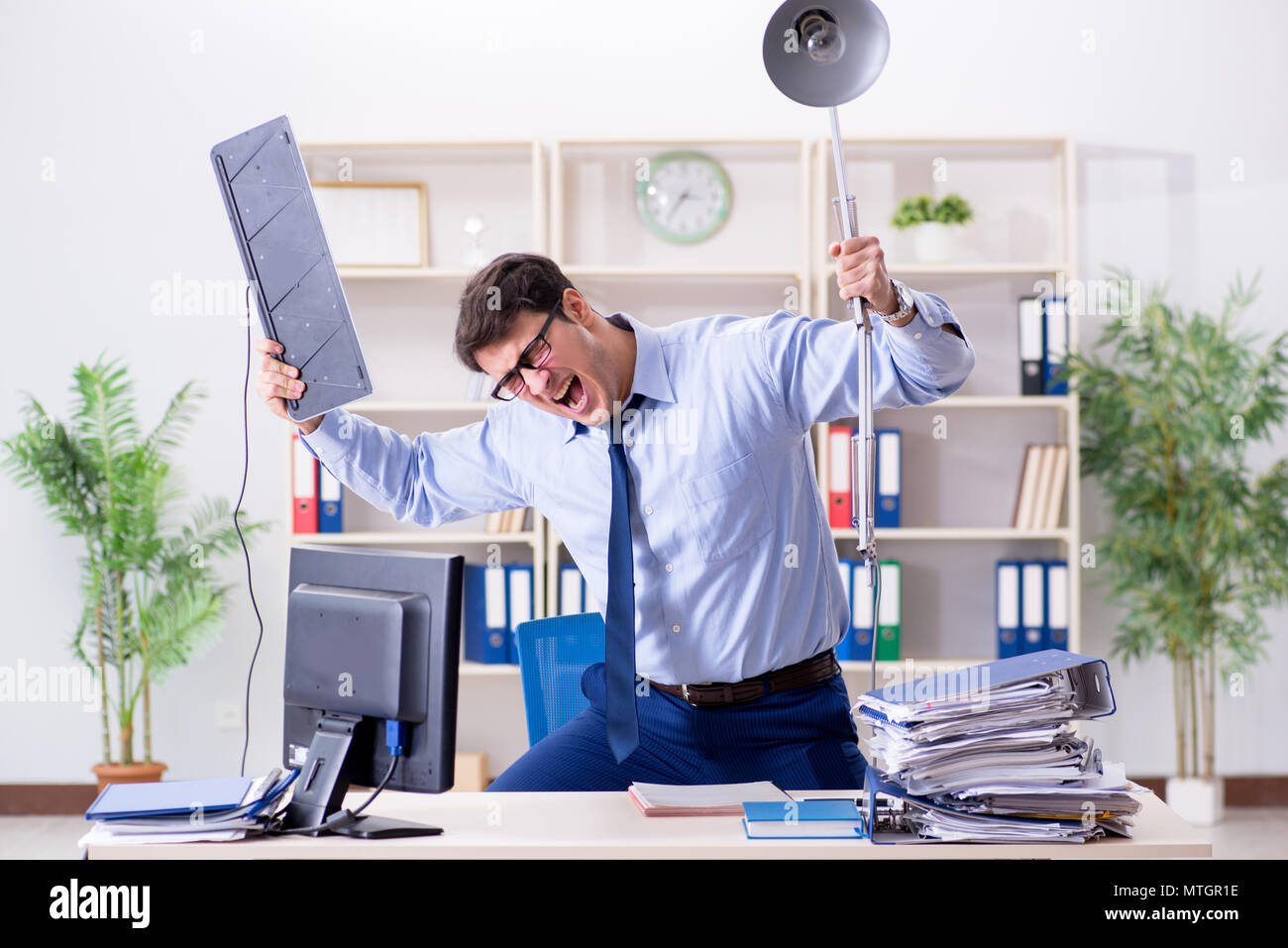 Angry businessman frustrated with too much work Stock Photo - Alamy
