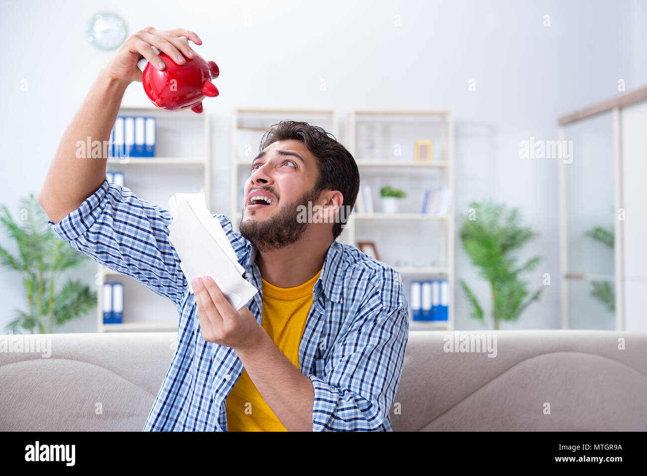 Man angry at bills he needs to pay Stock Photo - Alamy