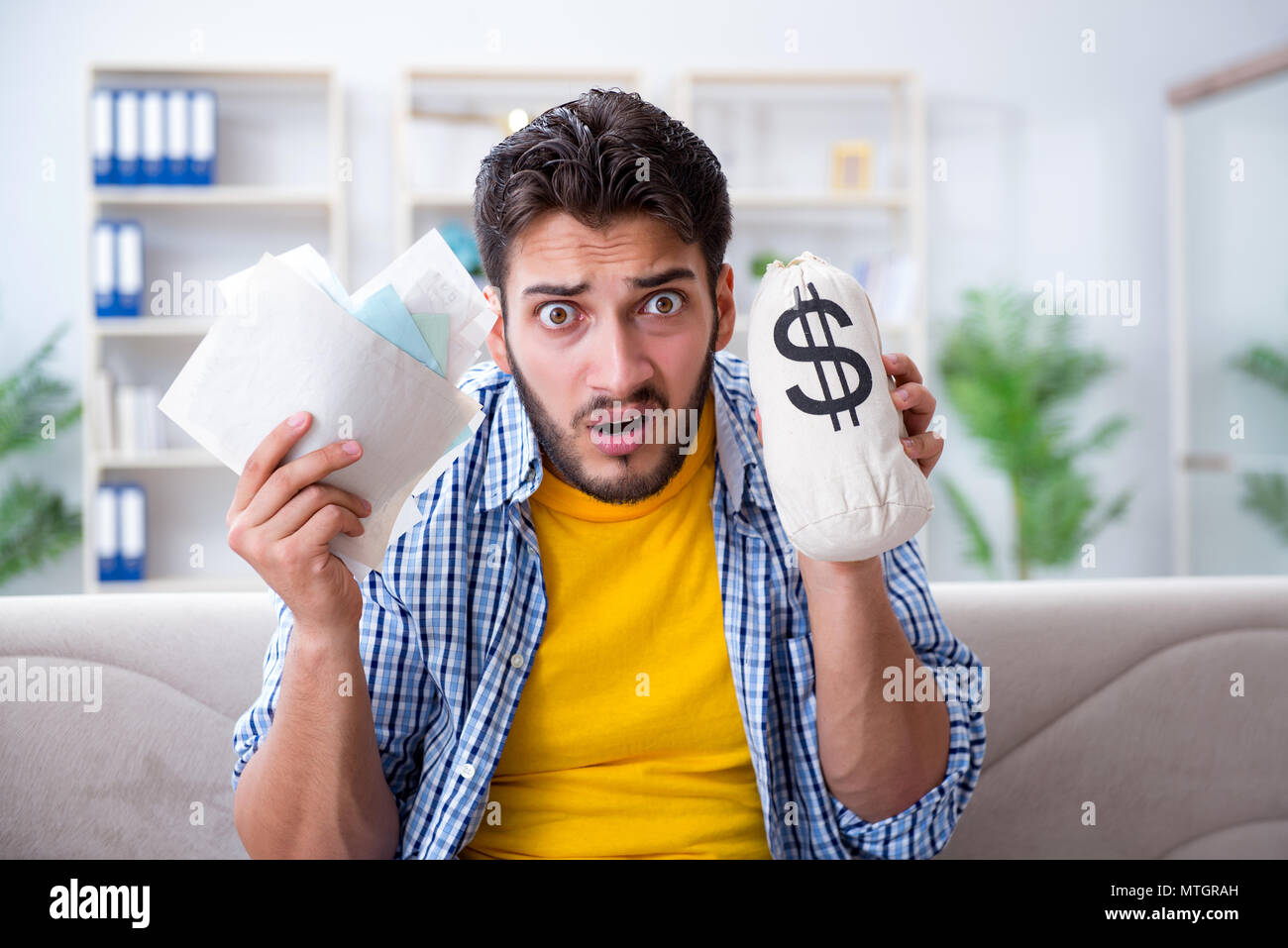 Man angry at bills he needs to pay Stock Photo - Alamy
