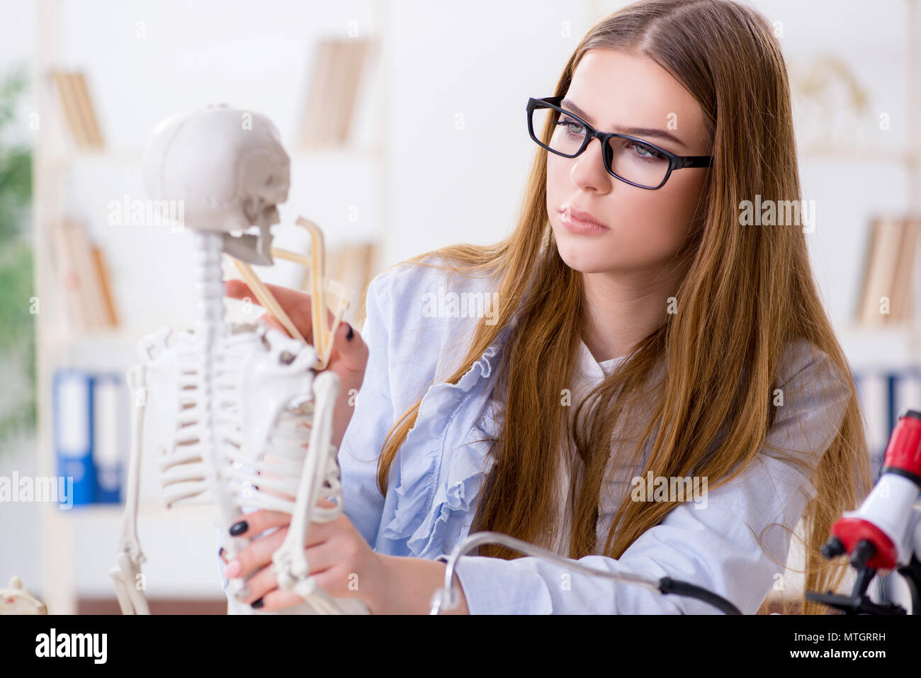 Student sitting in classroom and studying skeleton Stock Photo - Alamy
