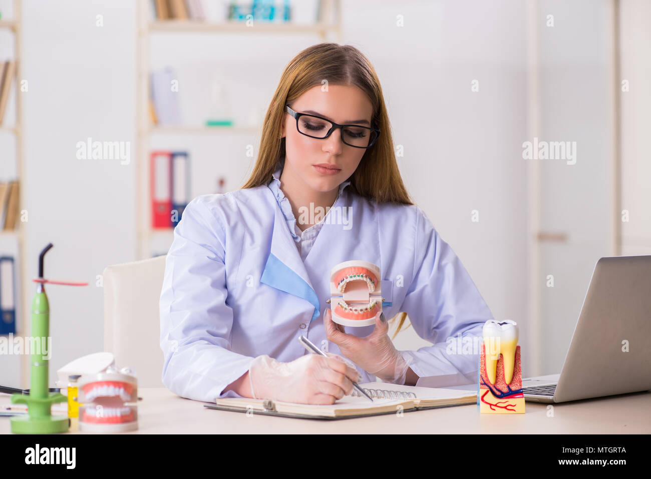 Dentistry student practicing skills in classroom Stock Photo - Alamy