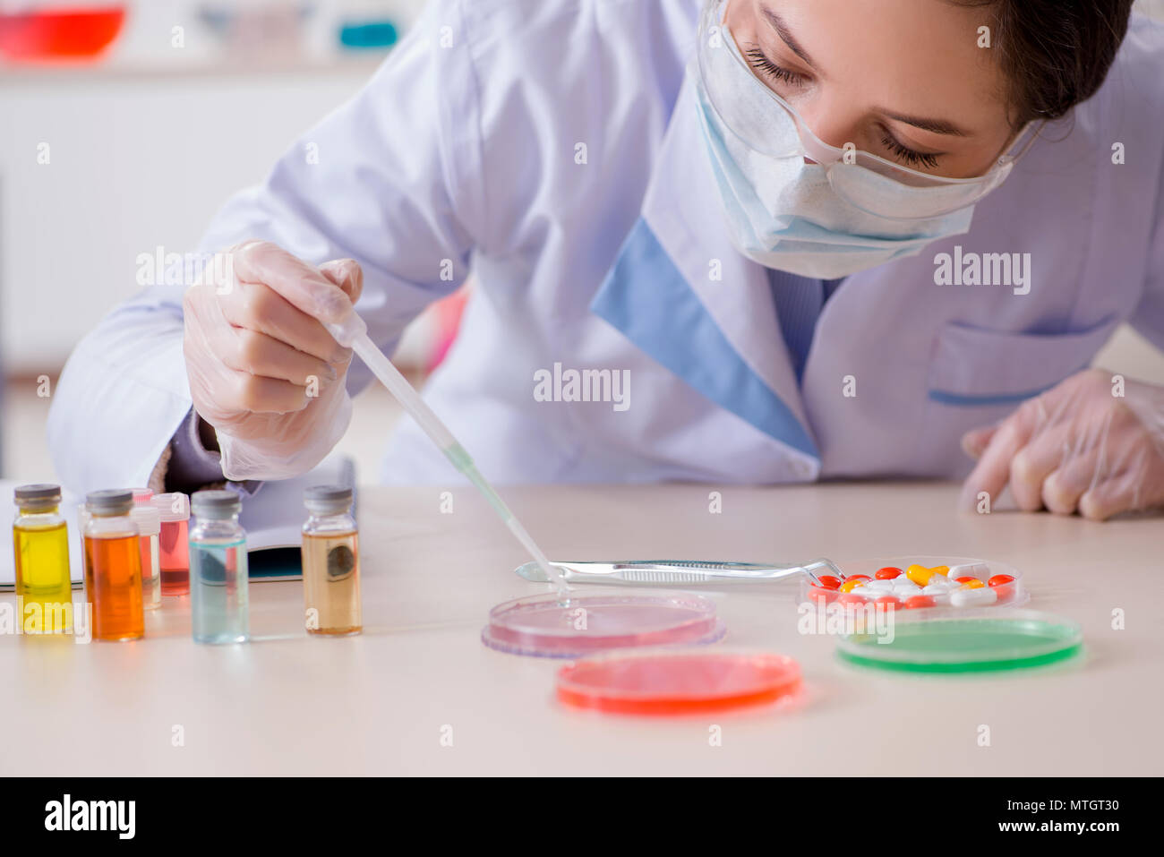 Lab assistant in drug synthesis concept Stock Photo - Alamy