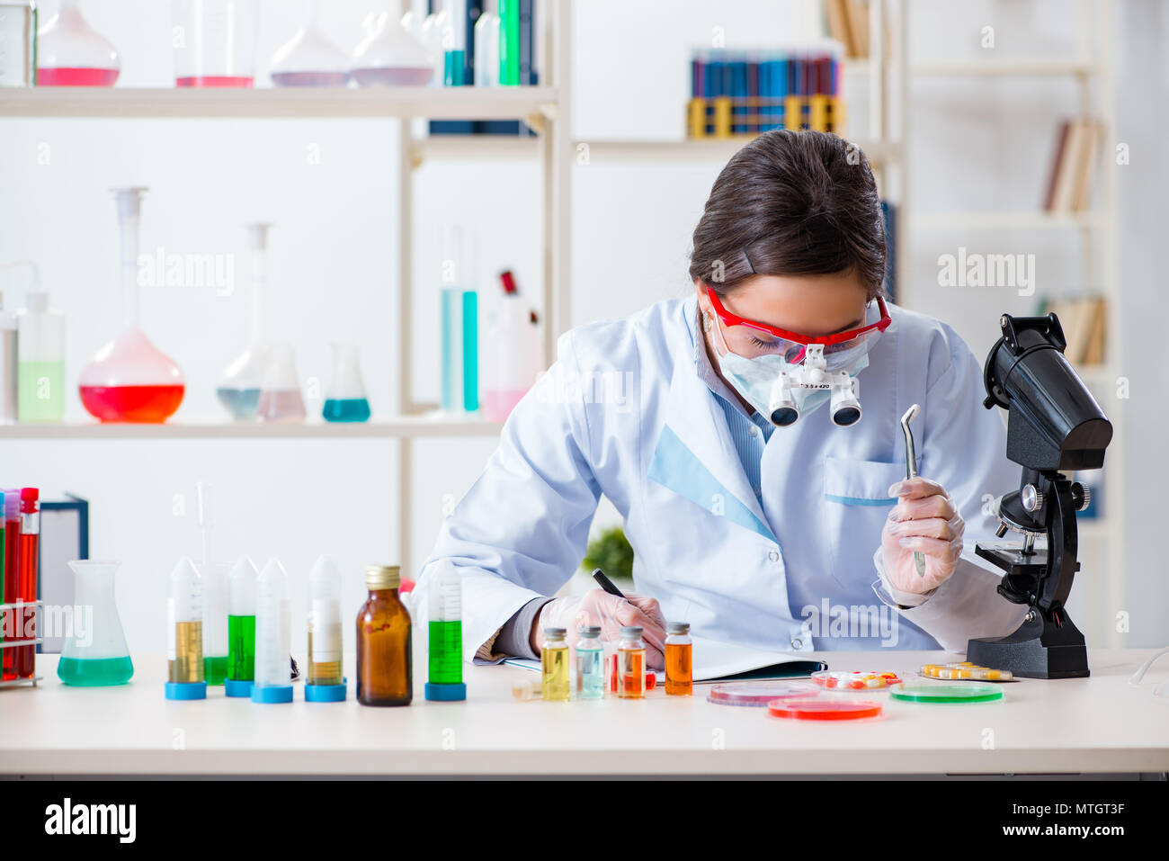 Lab assistant in drug synthesis concept Stock Photo - Alamy