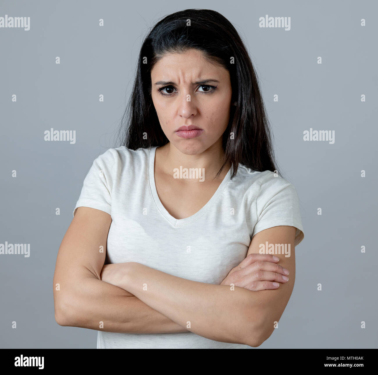 Close up portrait of an attractive young latin woman with an angry face ...