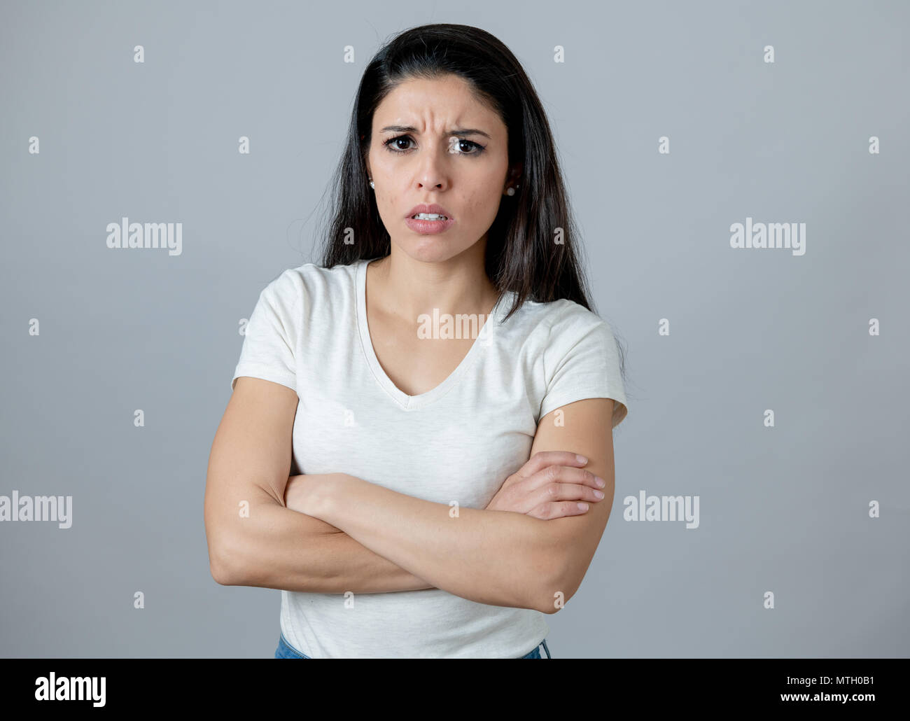 Close up portrait of an attractive young latin woman with an angry face ...