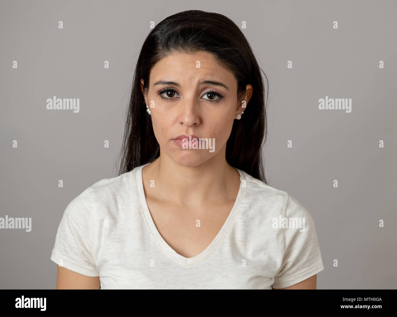 Close up portrait of a beautiful young latin hispanic woman with a sad ...