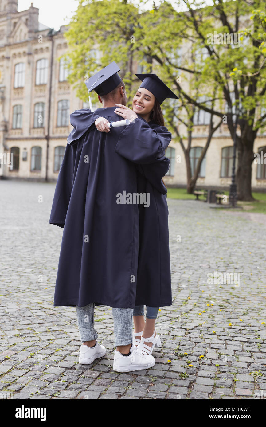 Two students in mortarboards hugging Stock Photo - Alamy