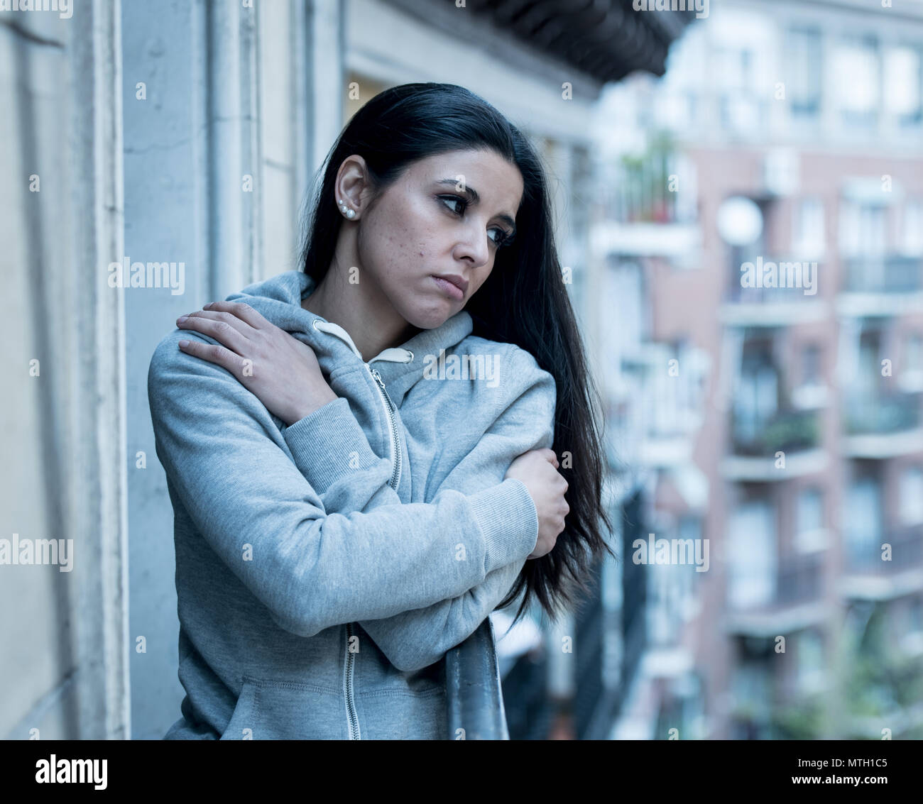 Attractive latin depressed lonely woman staring out feeling sad, pain ...