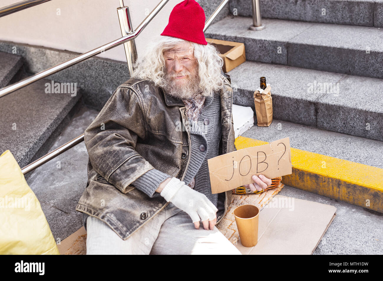 Aged homeless man holding a job sign Stock Photo - Alamy