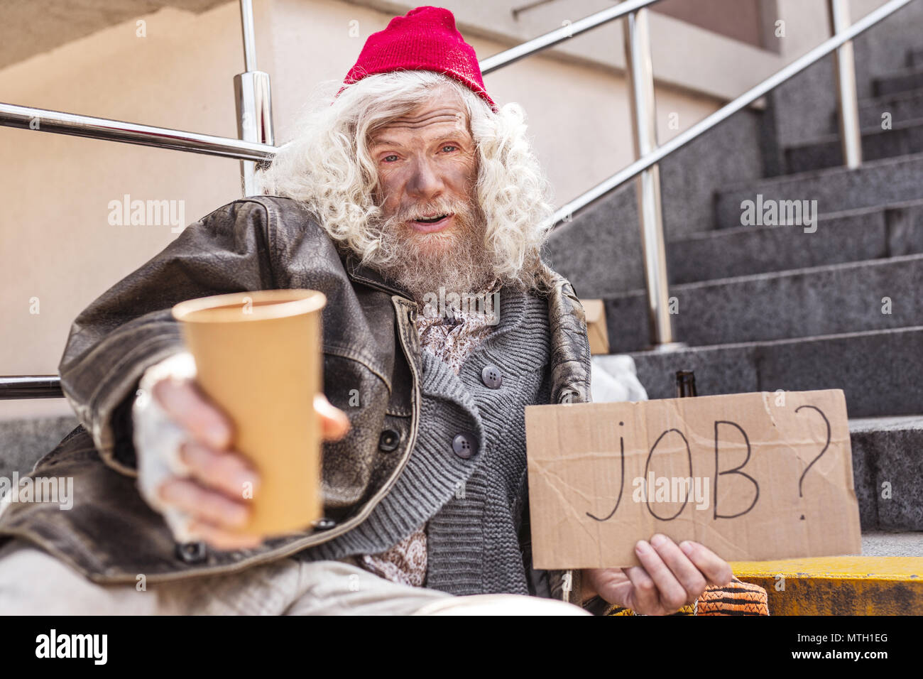 Homeless holding cup hi-res stock photography and images - Alamy