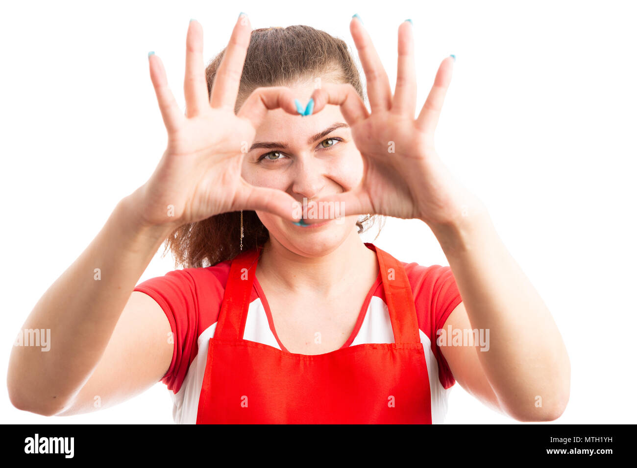 Young joyful woman supermarket employee or store owner making heart ...