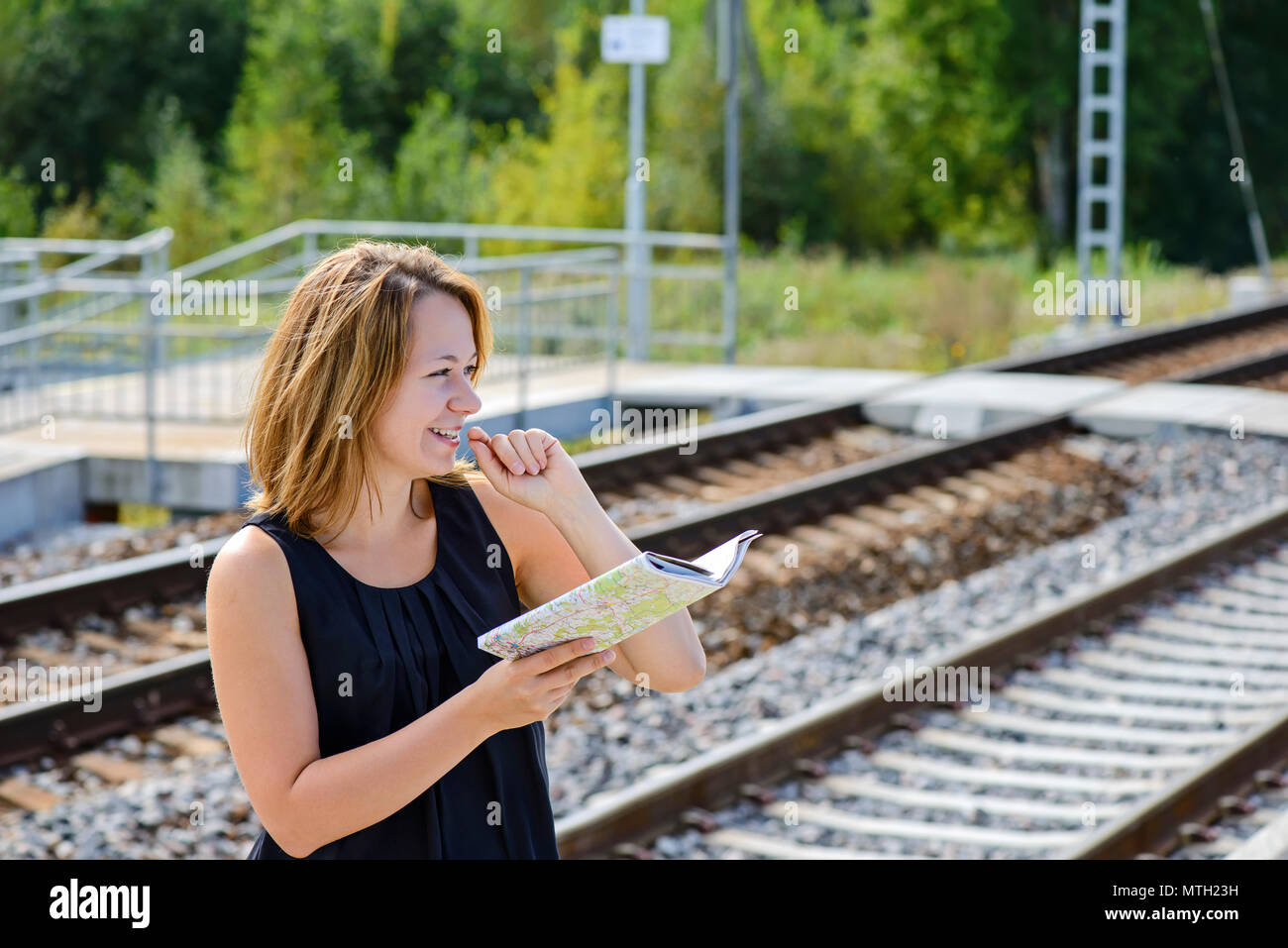 Female waiting train on the platform Stock Photo - Alamy