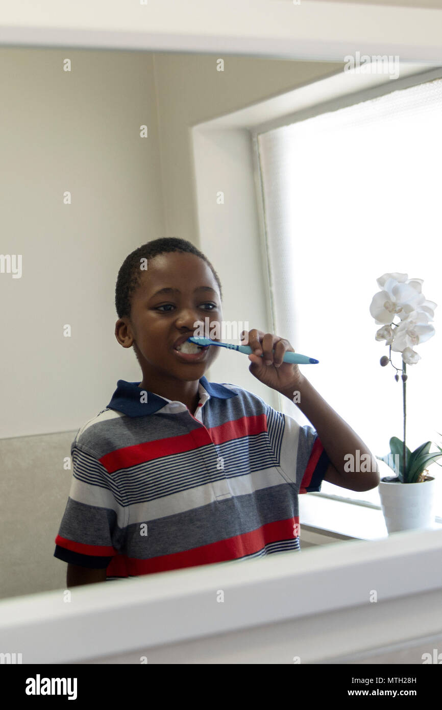 Boy brushing teeth in bathroom Stock Photo - Alamy