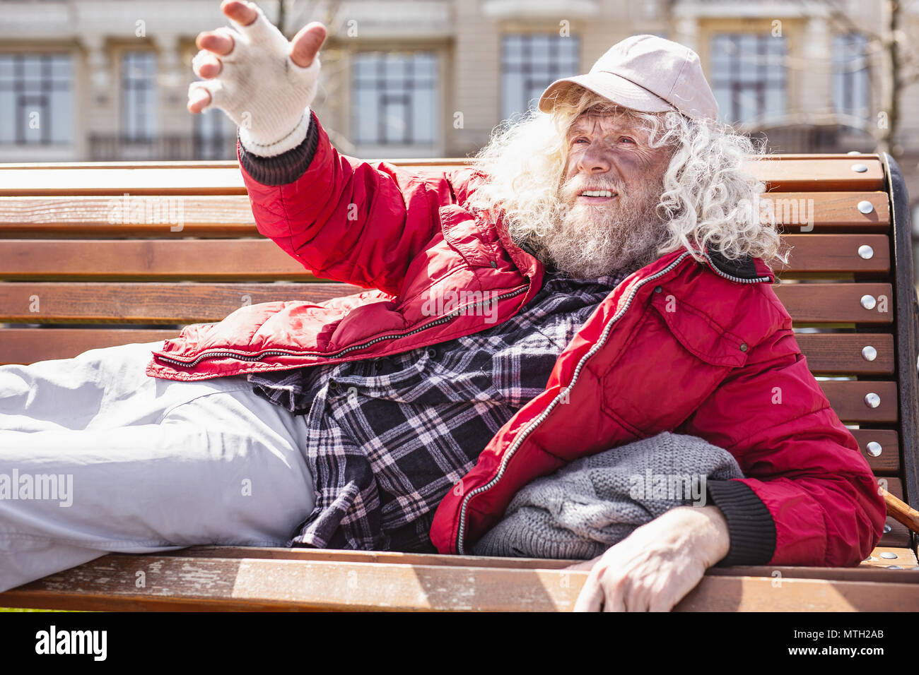 Cheerless poor man stretching out his hand Stock Photo - Alamy