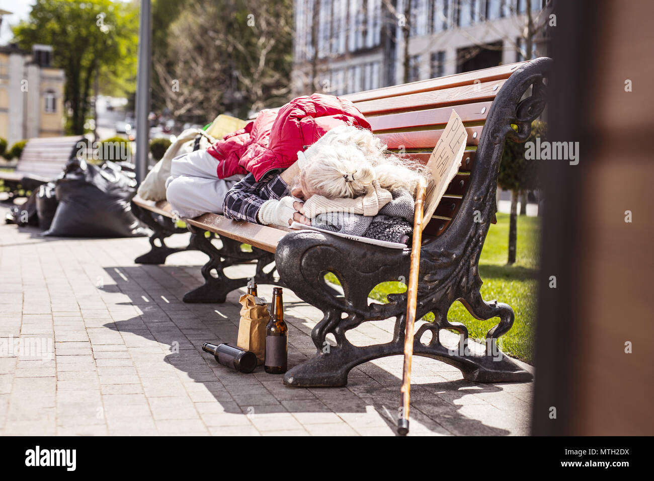 Unhappy poor man living on the street Stock Photo - Alamy