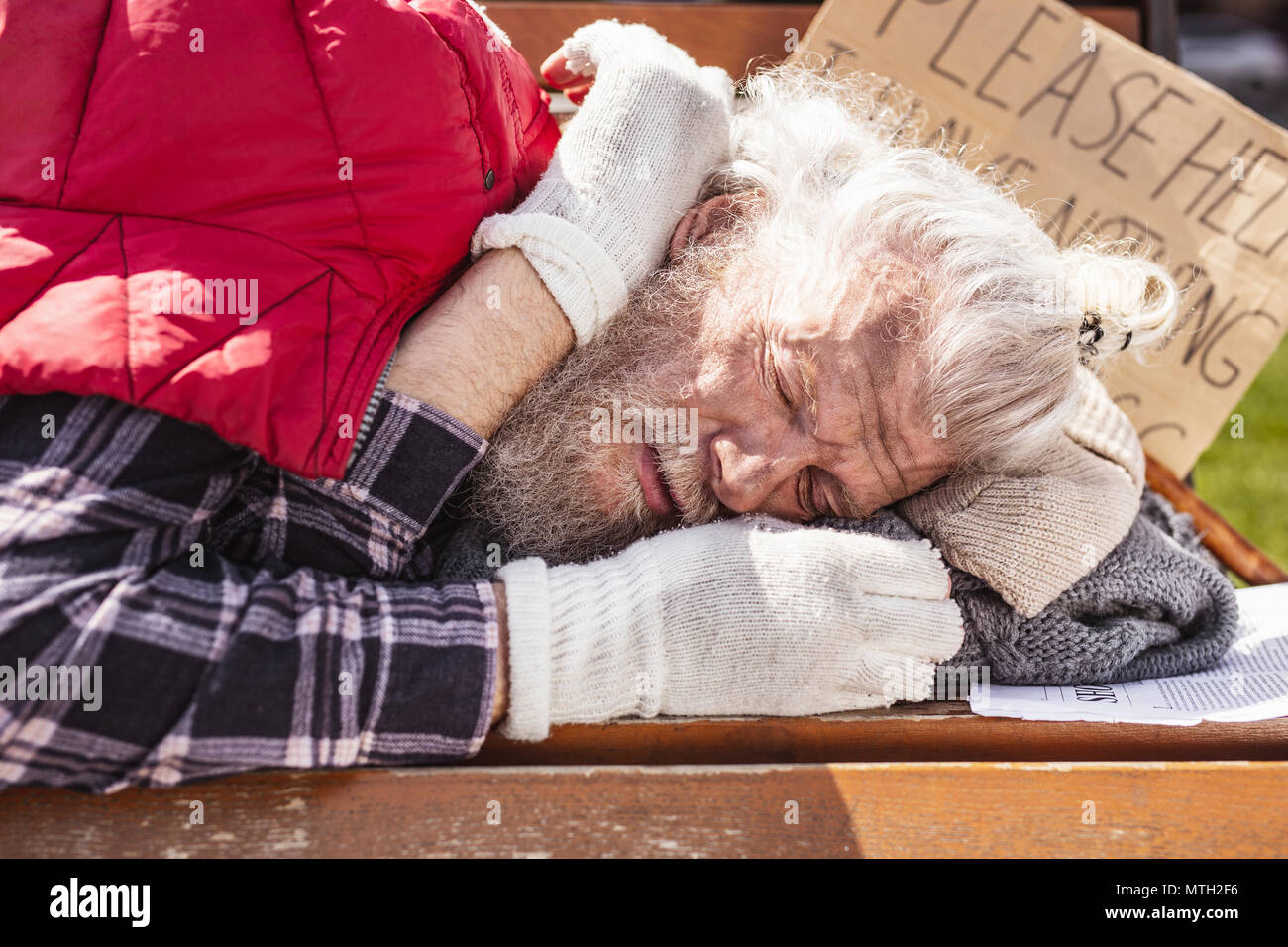 Homeless aged man lying on the bench Stock Photo - Alamy