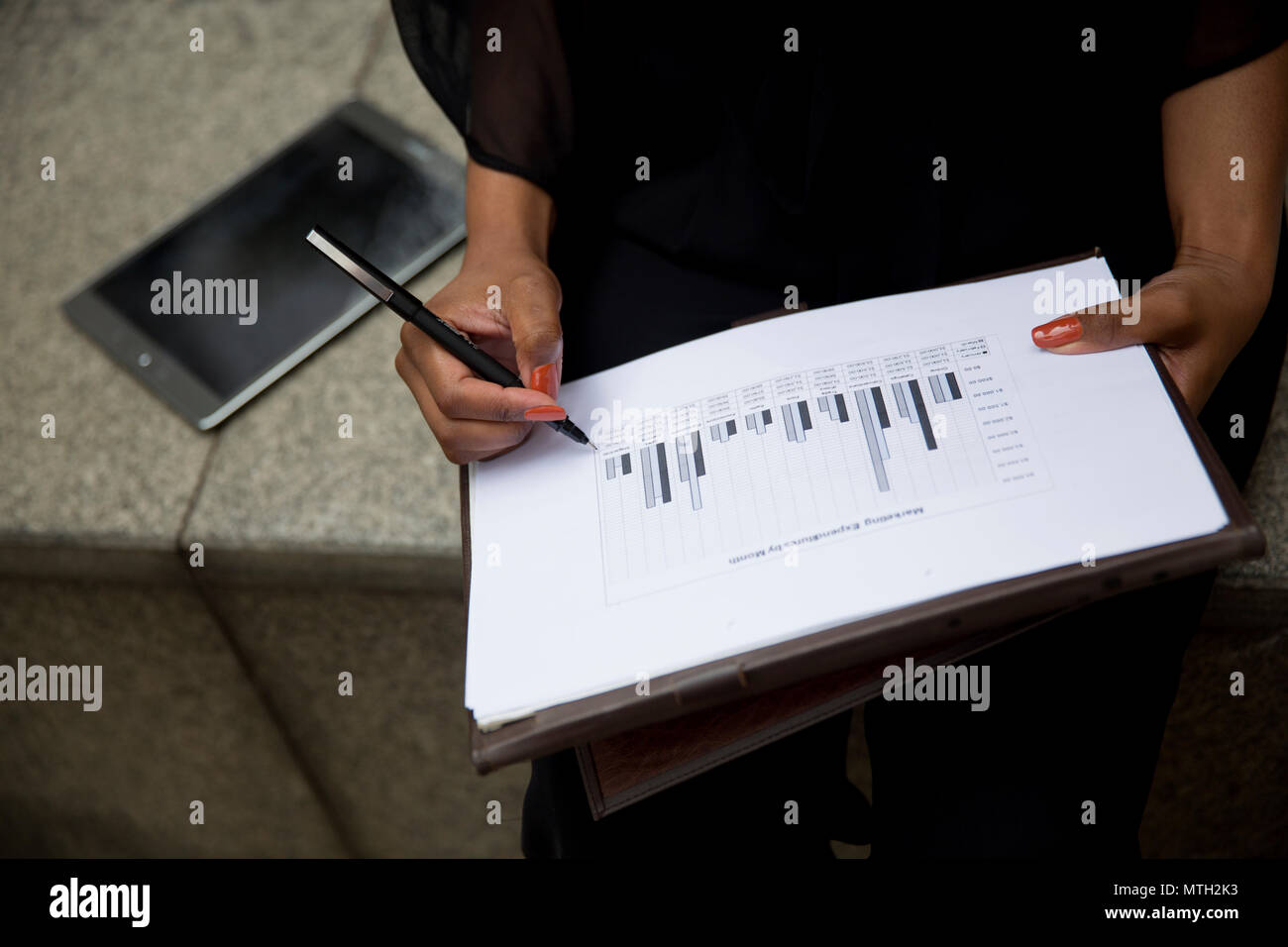 Business woman working on a graph Stock Photo - Alamy