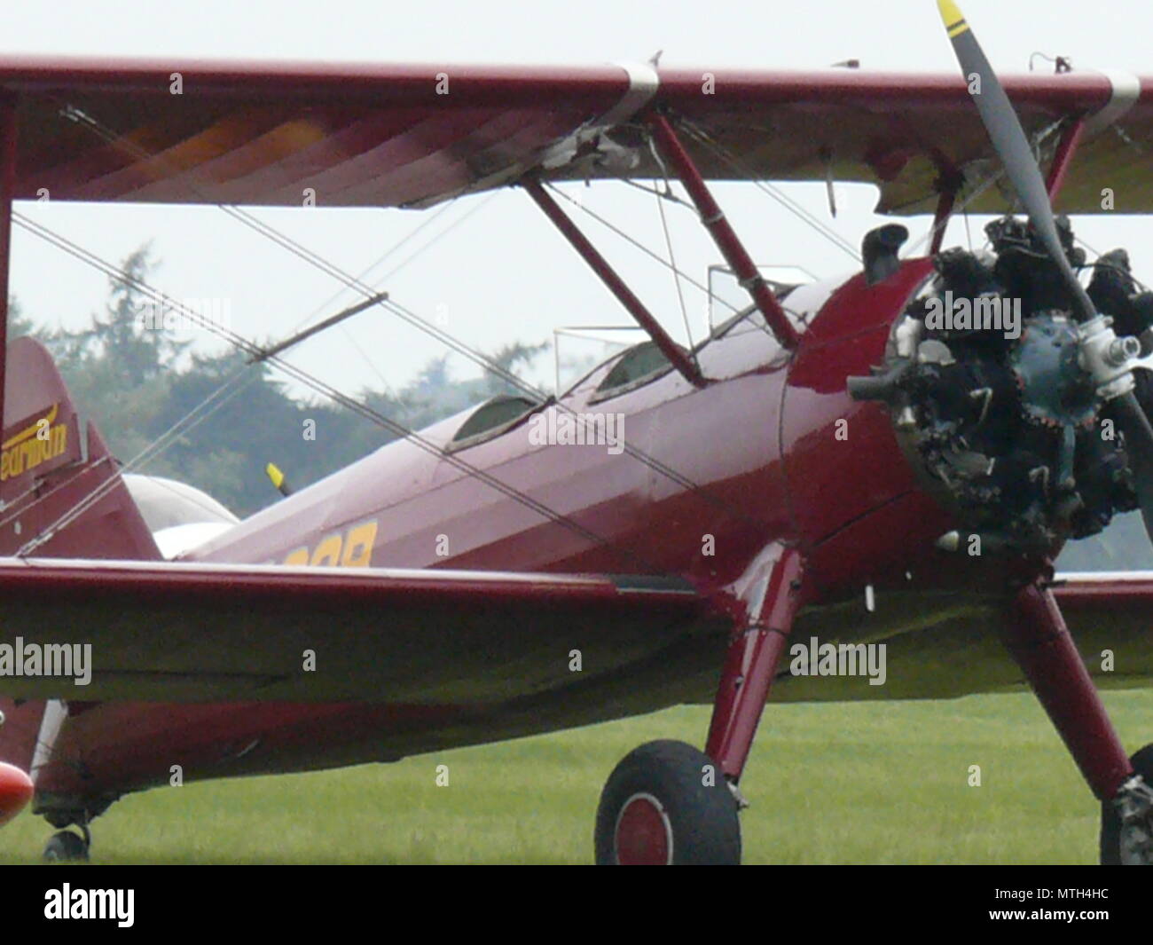 Red biplane, with propeller, at an airfield Stock Photo - Alamy