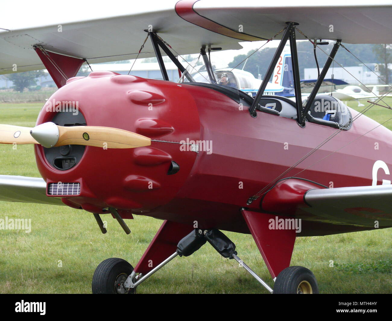 Red biplane with propeller, at the airfield Stock Photo - Alamy