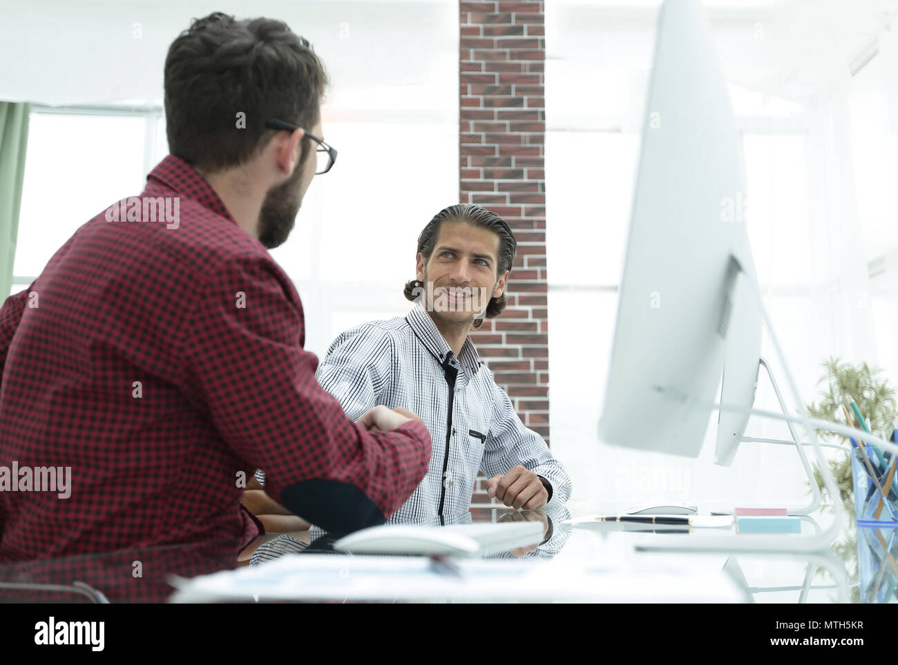 Two men handshake in the office Stock Photo - Alamy