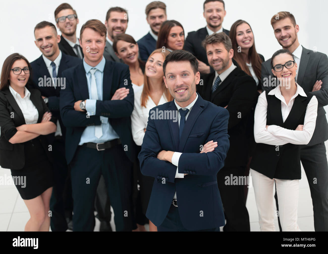 leader standing in front of a large business team Stock Photo - Alamy